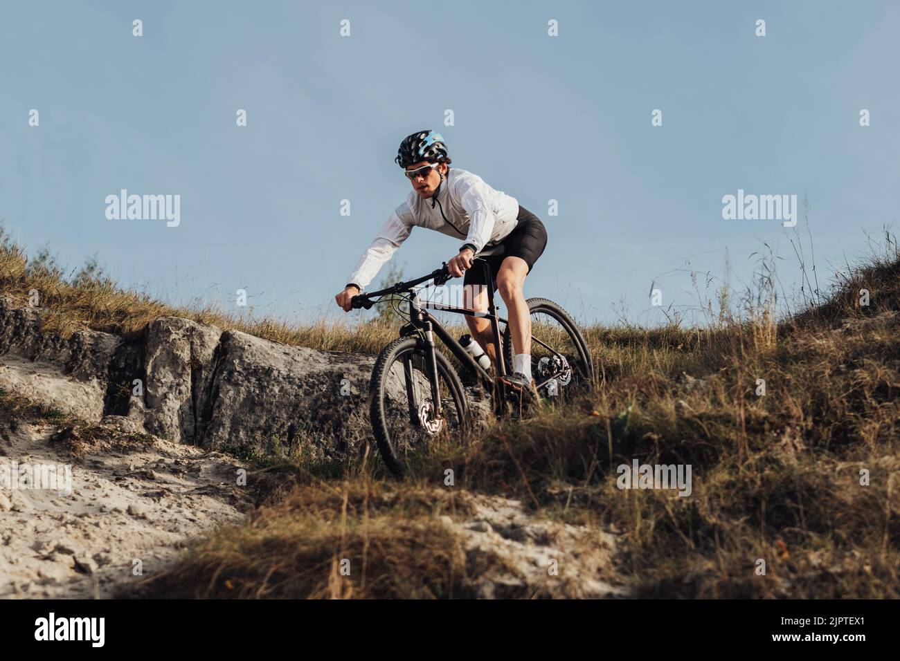 Equipped Professional Cyclist Descends a Slope on His Mountain Bike ...