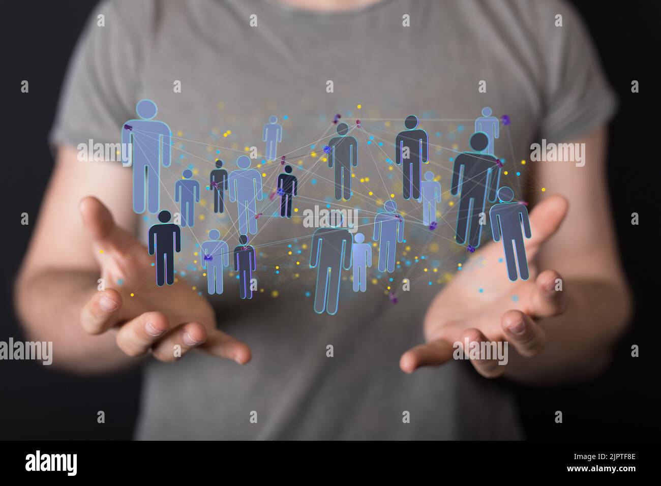 A man's hand pressing a group of illustrative human figures against a ...