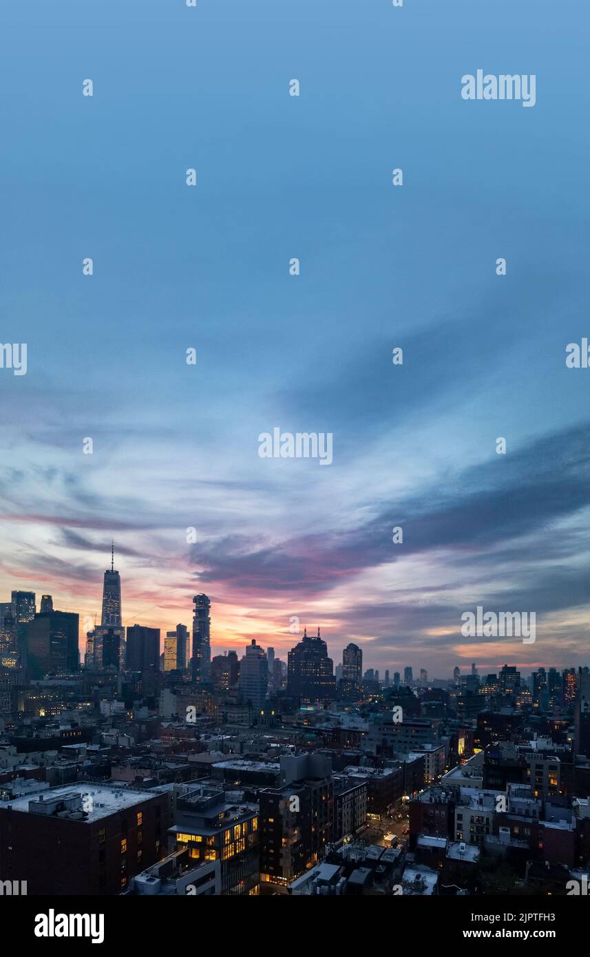 New York City skyline lights at dusk with empty blue sky above the ...