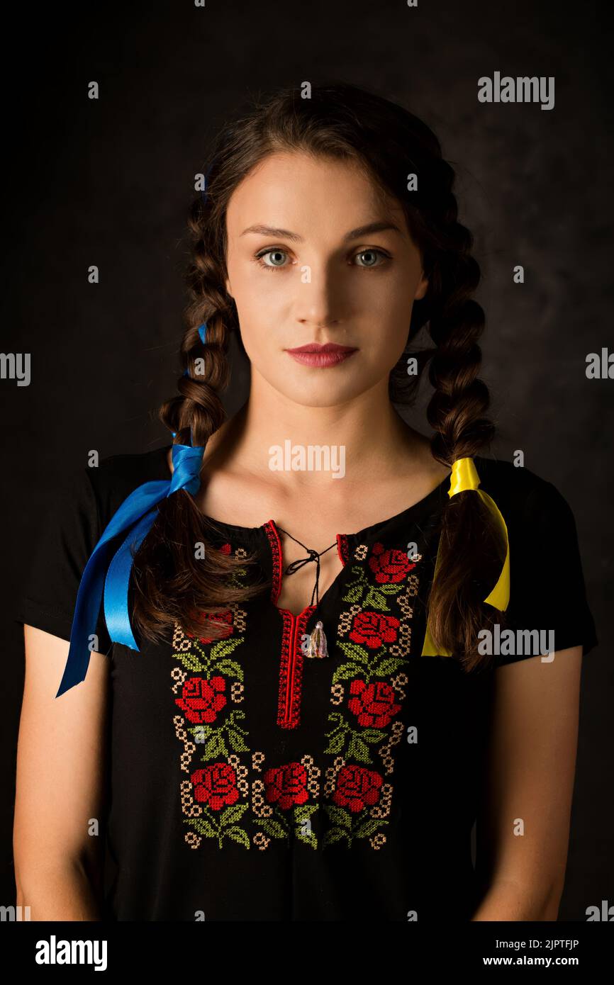 A girl with braided yellow and blue ribbons, the colors of the ...