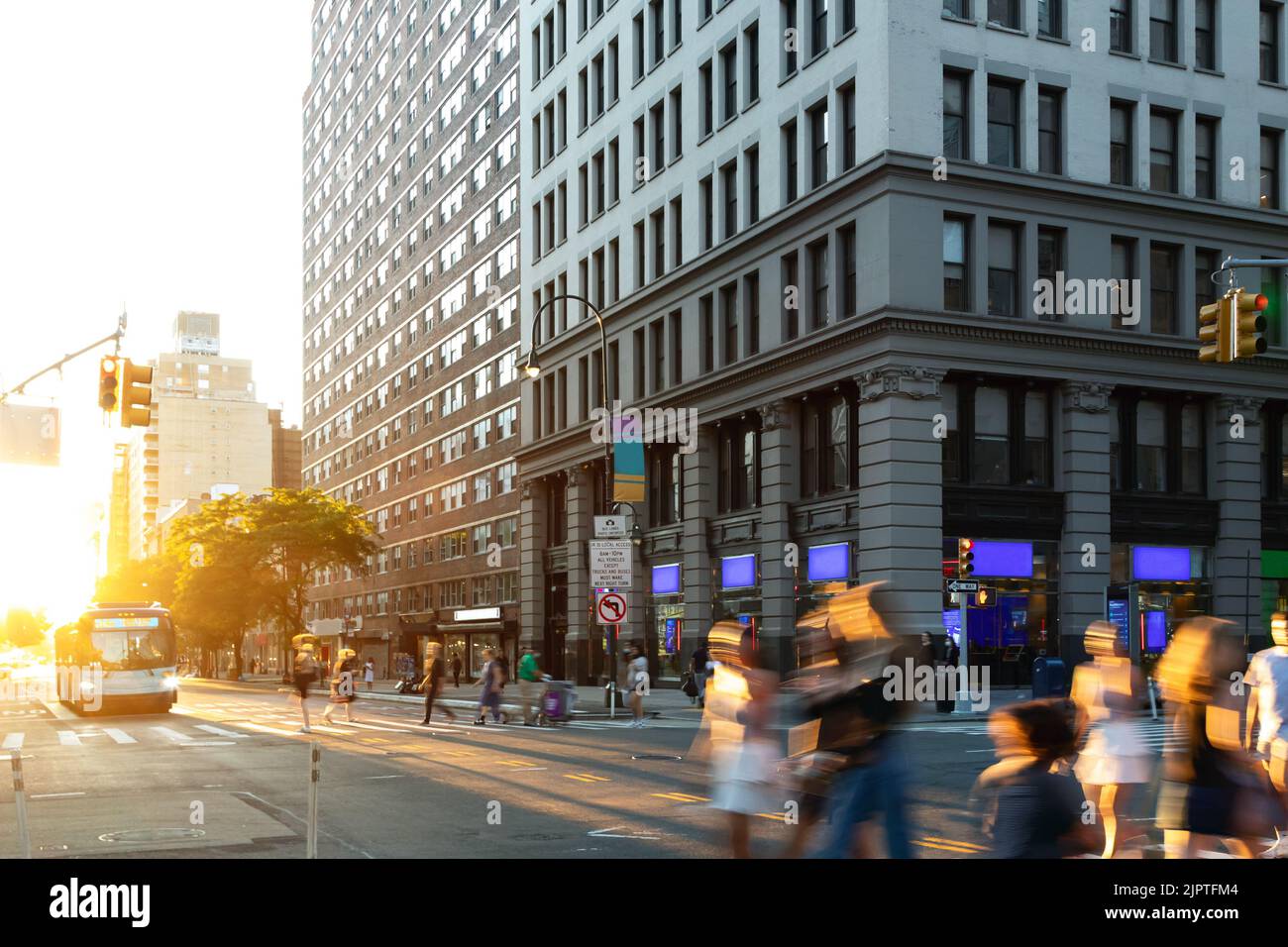 Crowds of people crossing a busy intersection on 5th Avenue in ...
