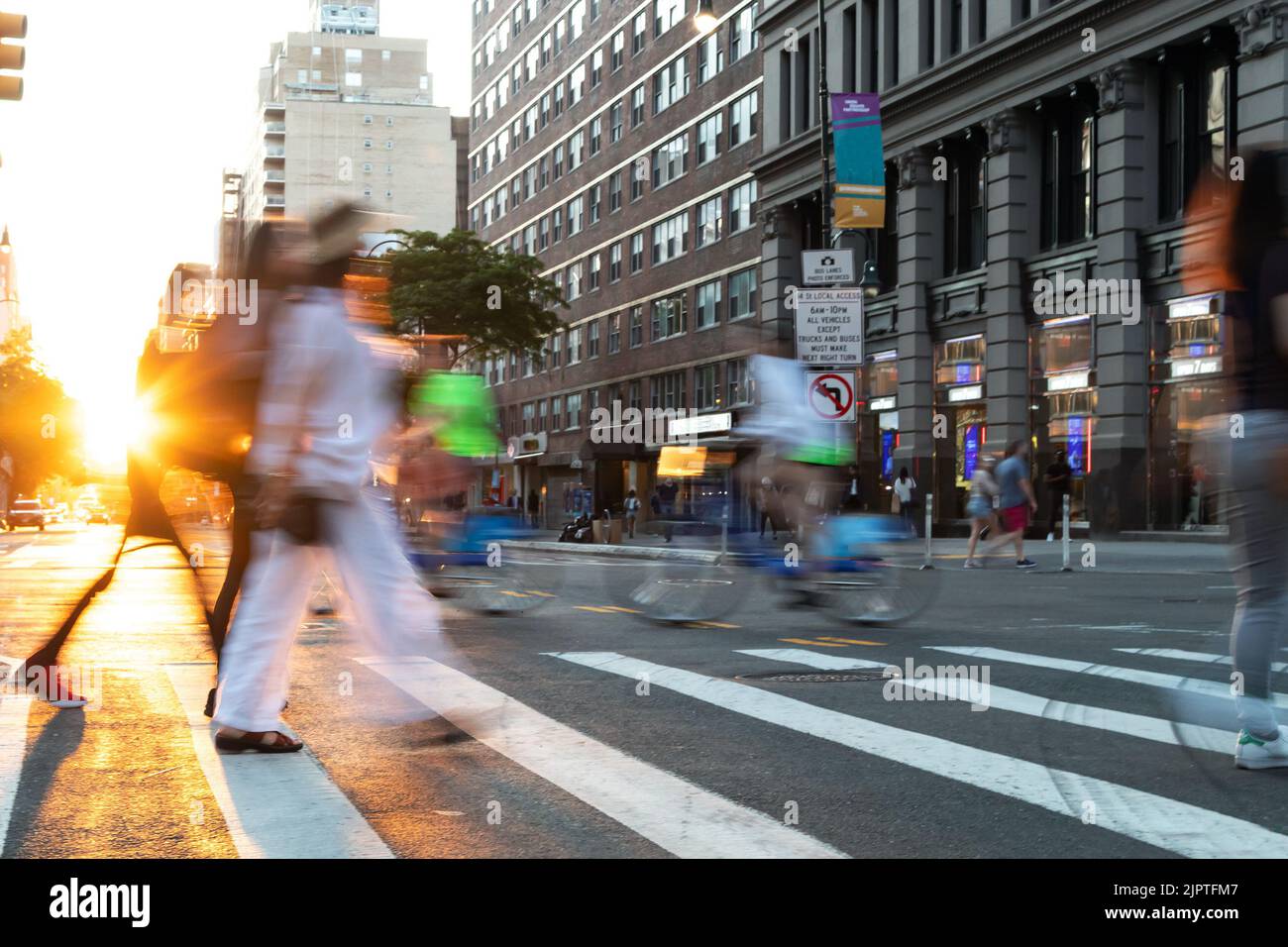 Busy street scene with people and bikes at an intersection on 5th ...