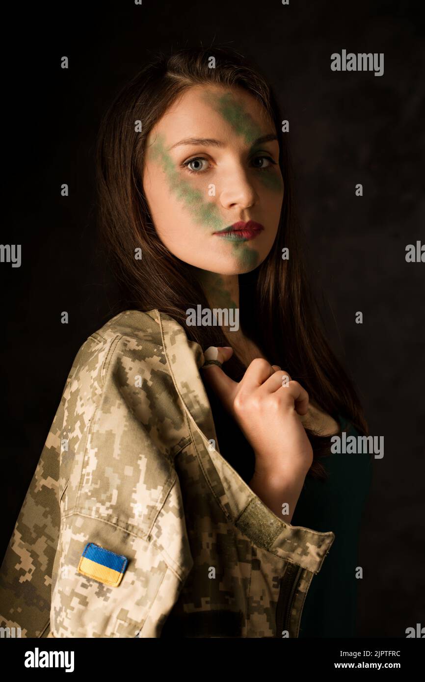 Ukrainian female defender with striped military make-up Stock Photo - Alamy