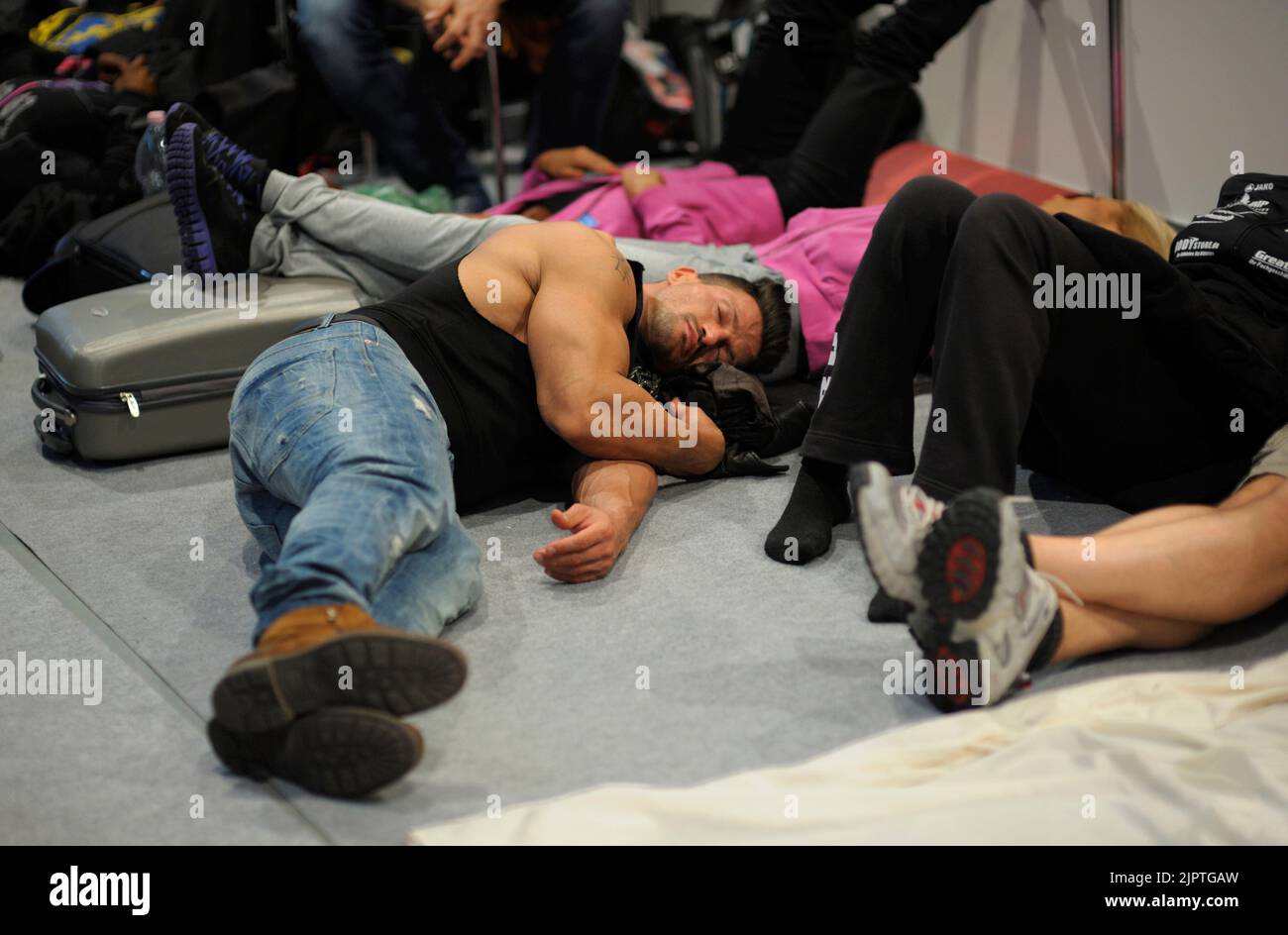 Muscular man bodybuilder lying on the floor sleeping at the changing ...