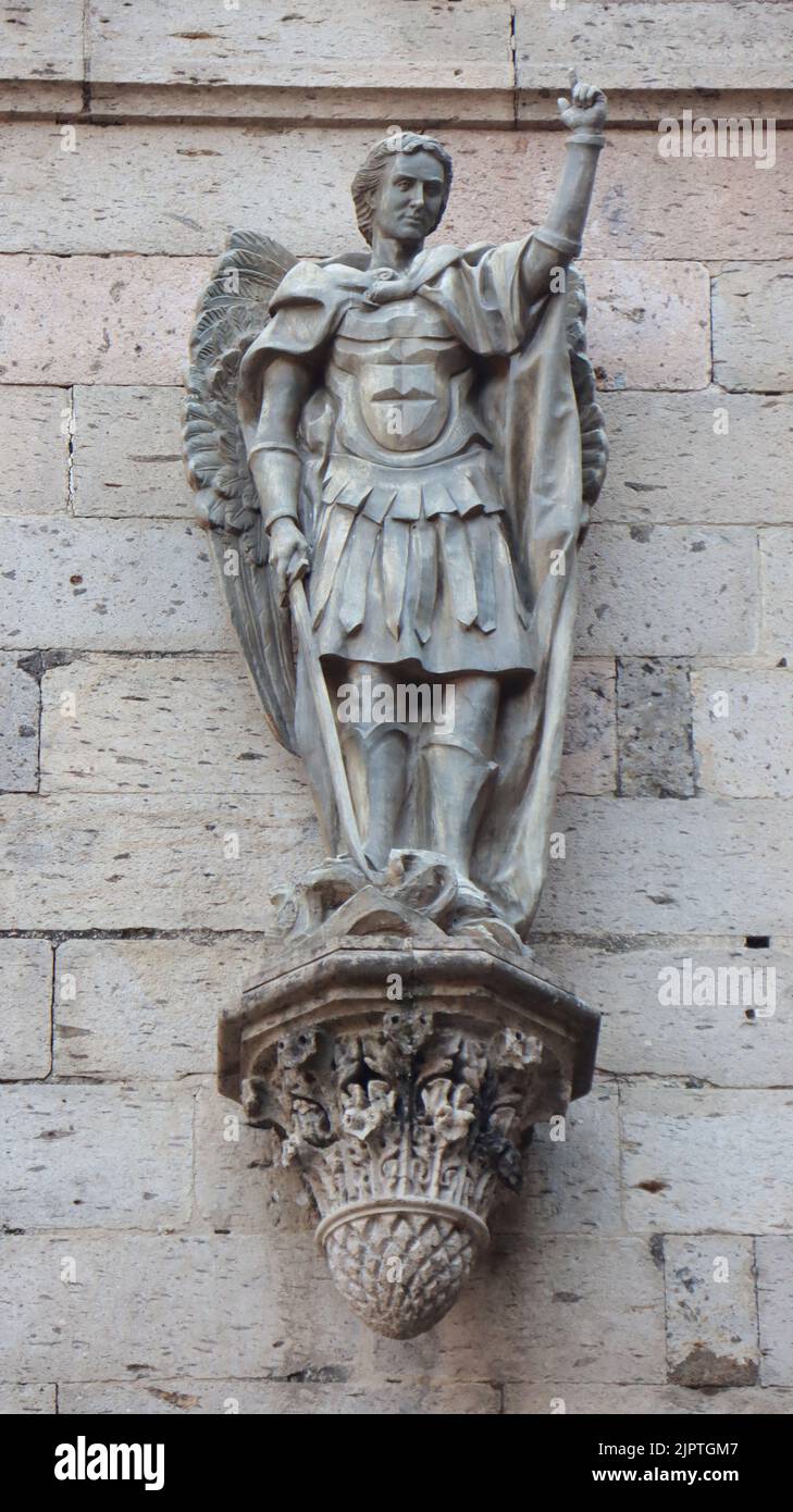 The vertical view of a marble statue of The saint Michael angel ...