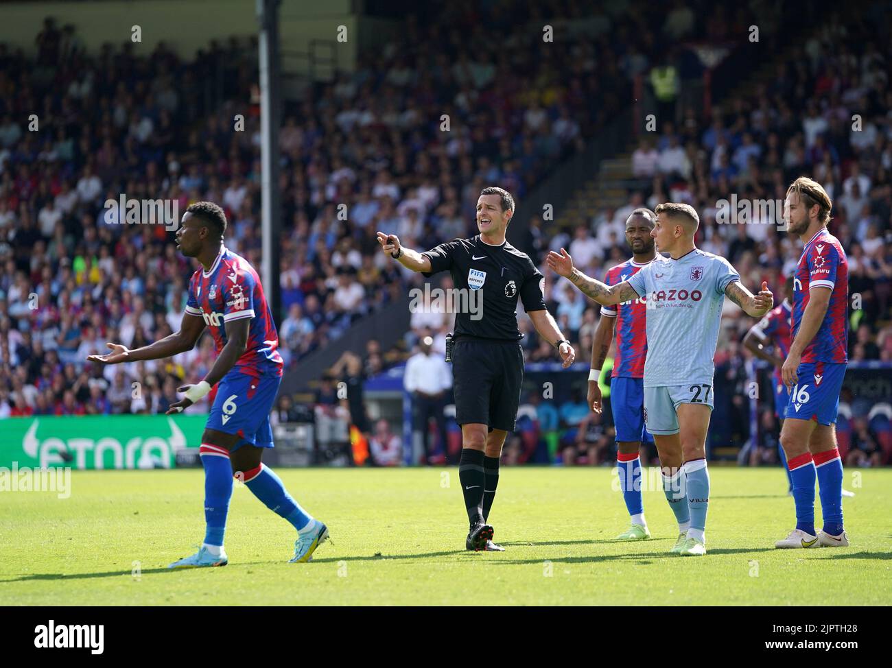 Referee Andrew Madley speaks to Crystal Palace's Marc Guehi (left) and ...
