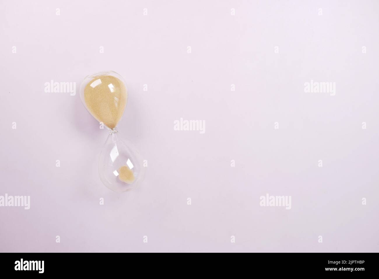 hourglass on table, sand flowing through the bulb of sandglass Stock ...