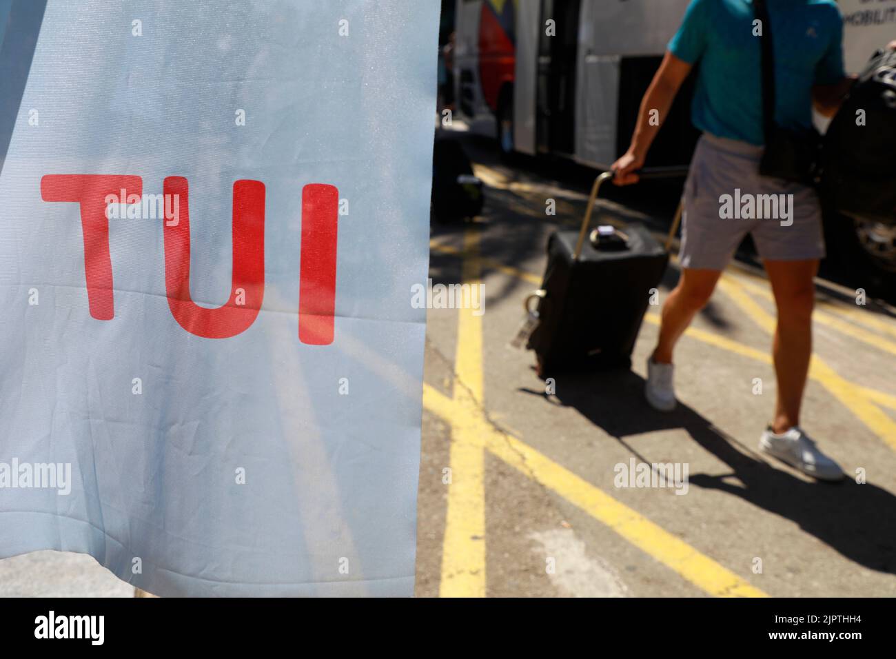 Palma, Spain. 20th Aug, 2022. A man walks towards a bus behind a TUI ...
