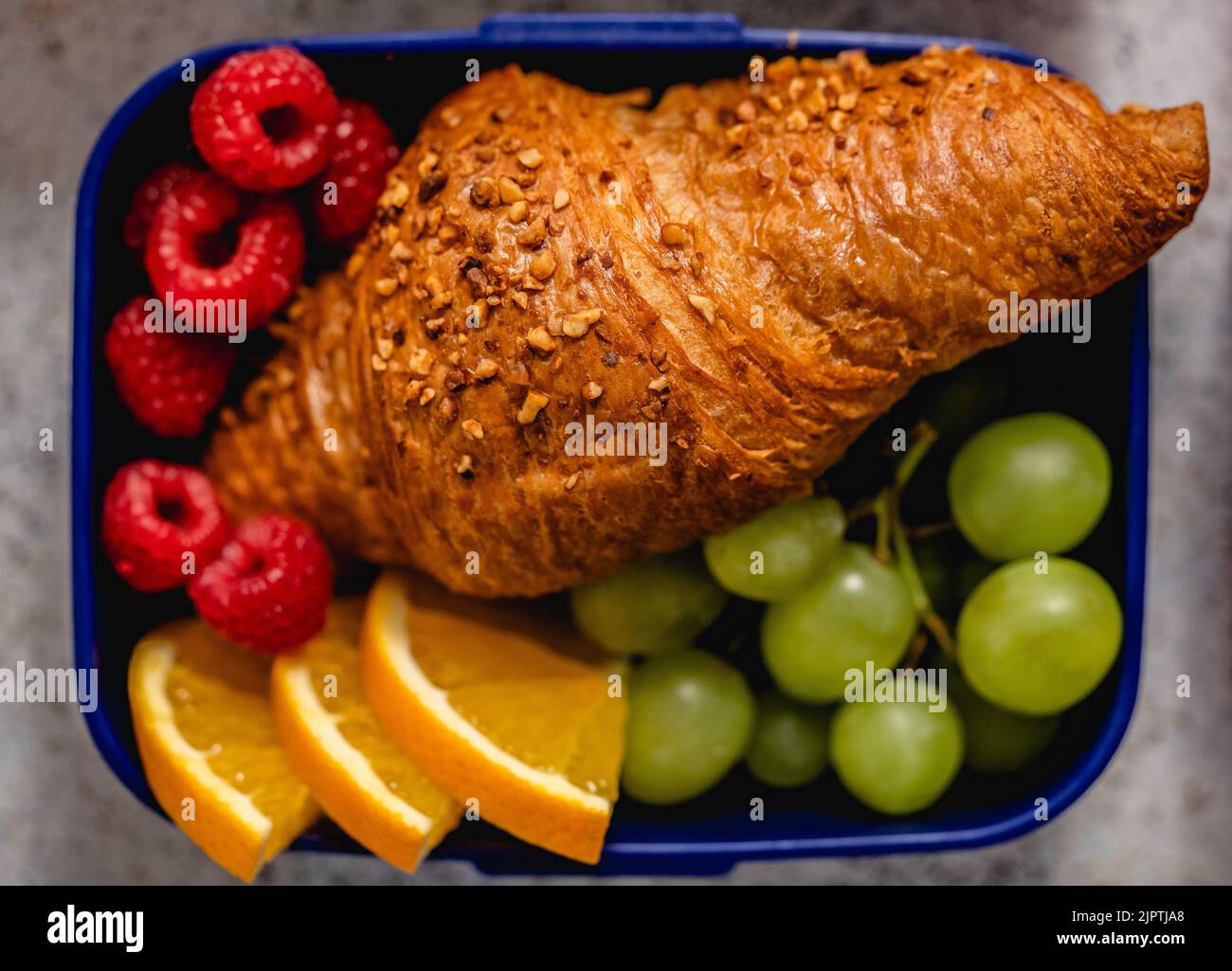 Lunch box with a sandwich croissant and fruit healthy snacks for school ...