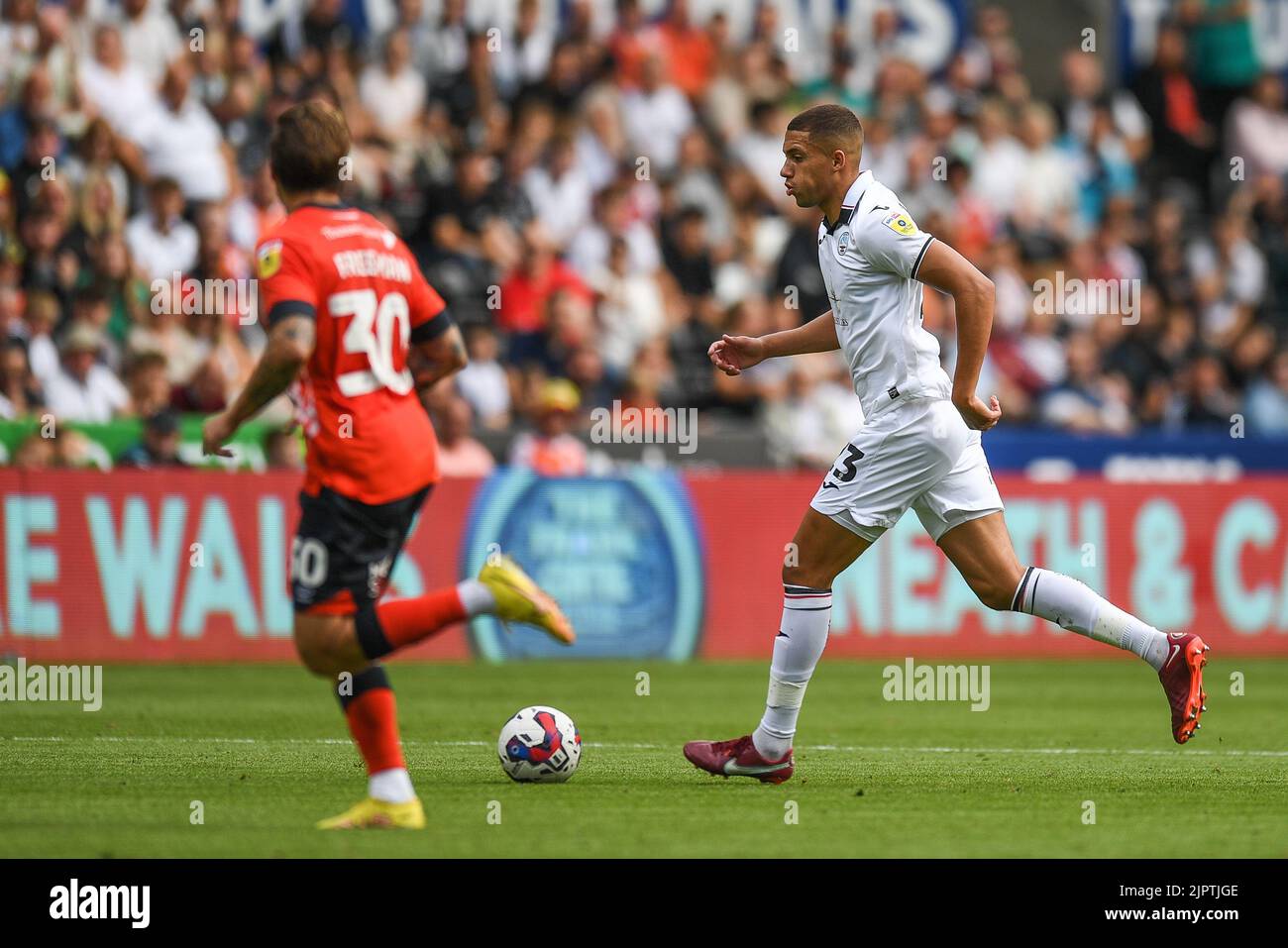 Nathan Wood #23 of Swansea City takes on Luke Freeman #30 of Luton Town ...