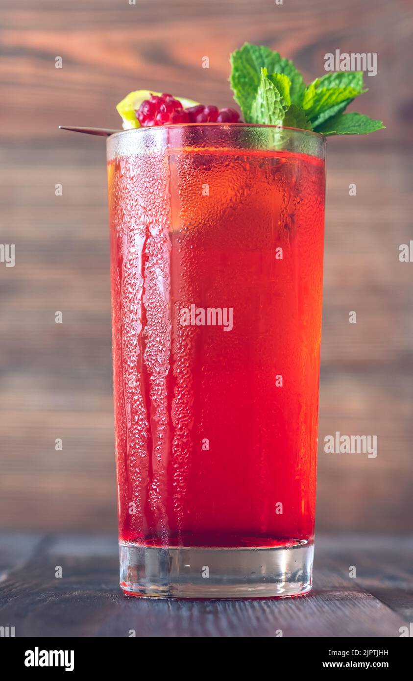 Glass of Raspberry Collins cocktail garnished with mint Stock Photo - Alamy