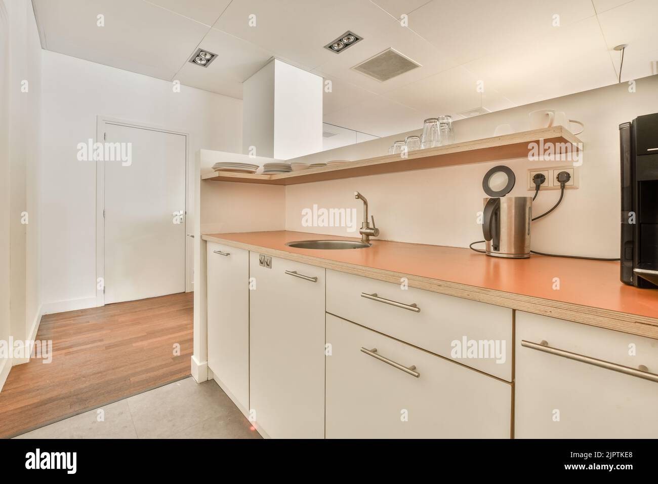 Table with chairs and flowers located near lounge area and kitchen in ...