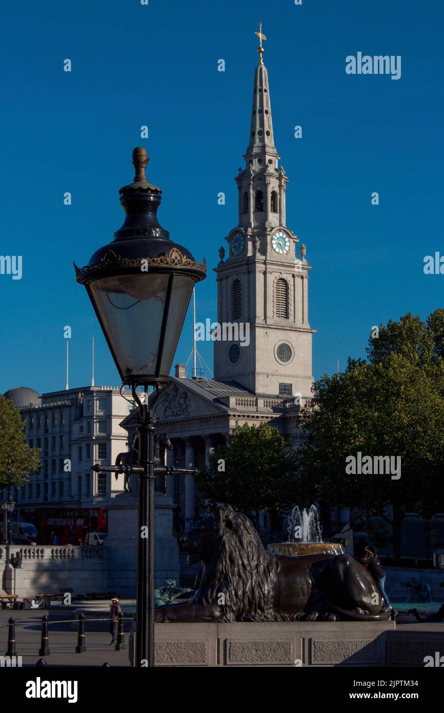 A vertical shot of a street light with a background of a lion's ...
