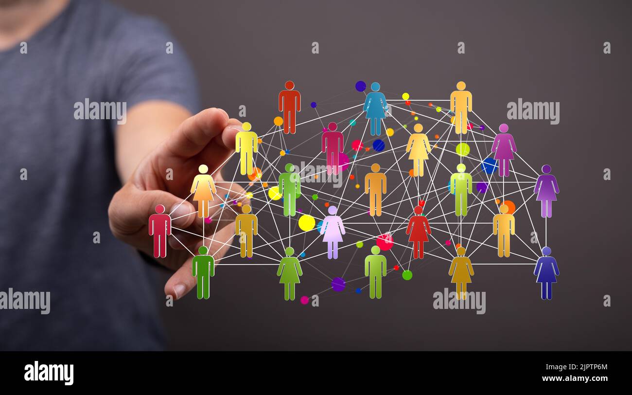 A person touching a 3D rendered hologram of colorful persons connecting ...