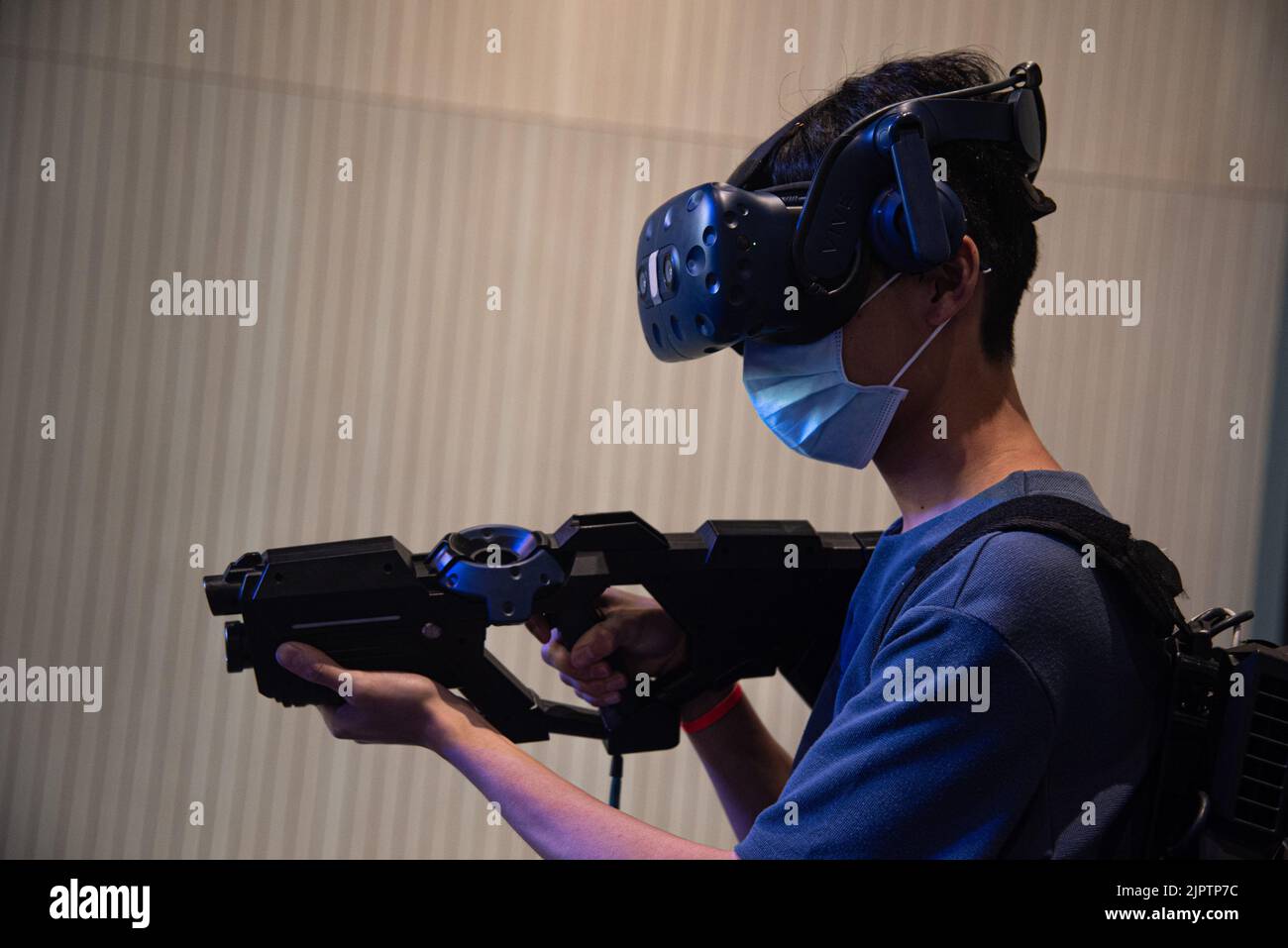 A visitor experiences a virtual reality (VR) on a battleground game at ...