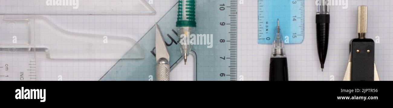Drafting architectural tools arranged on white quartile paper in banner ...