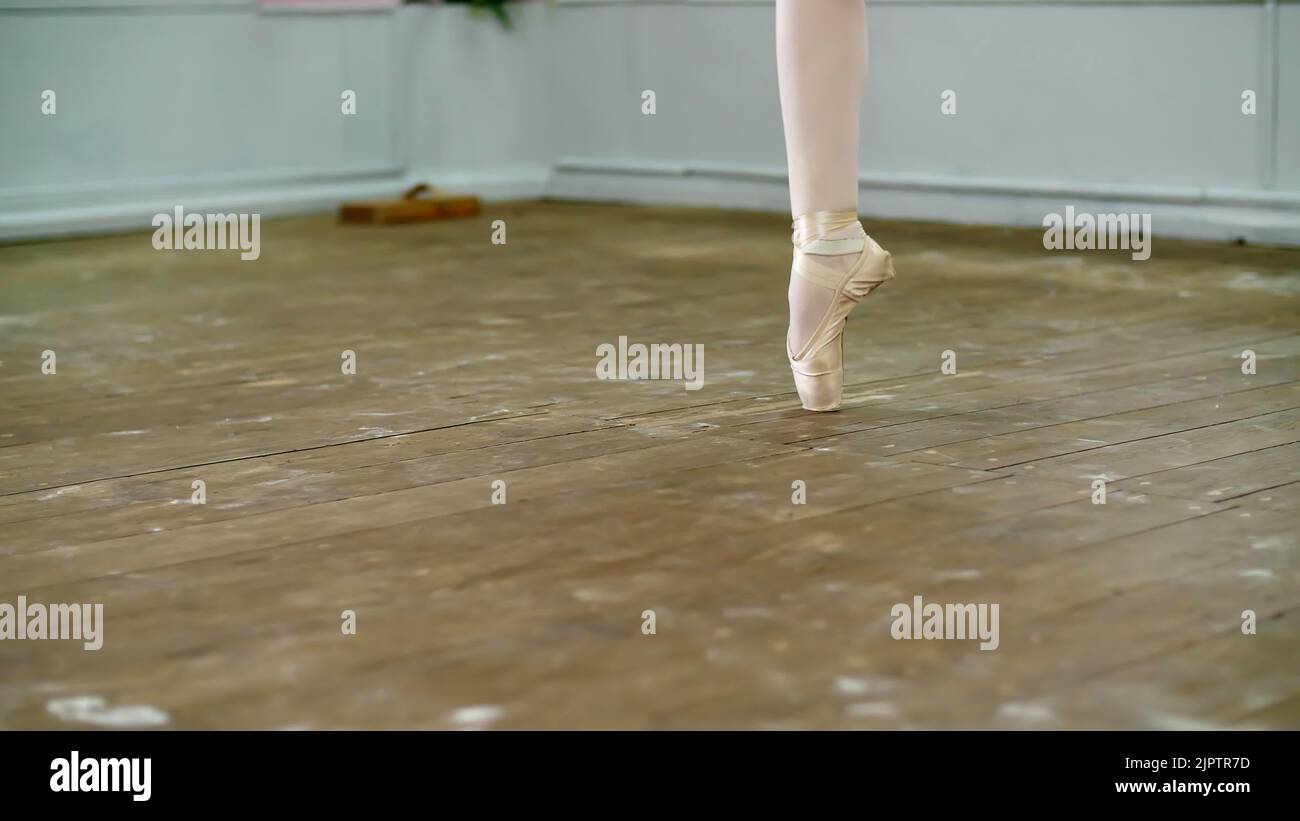 close up, in dancing hall, ballerina perform step pointe , She is ...