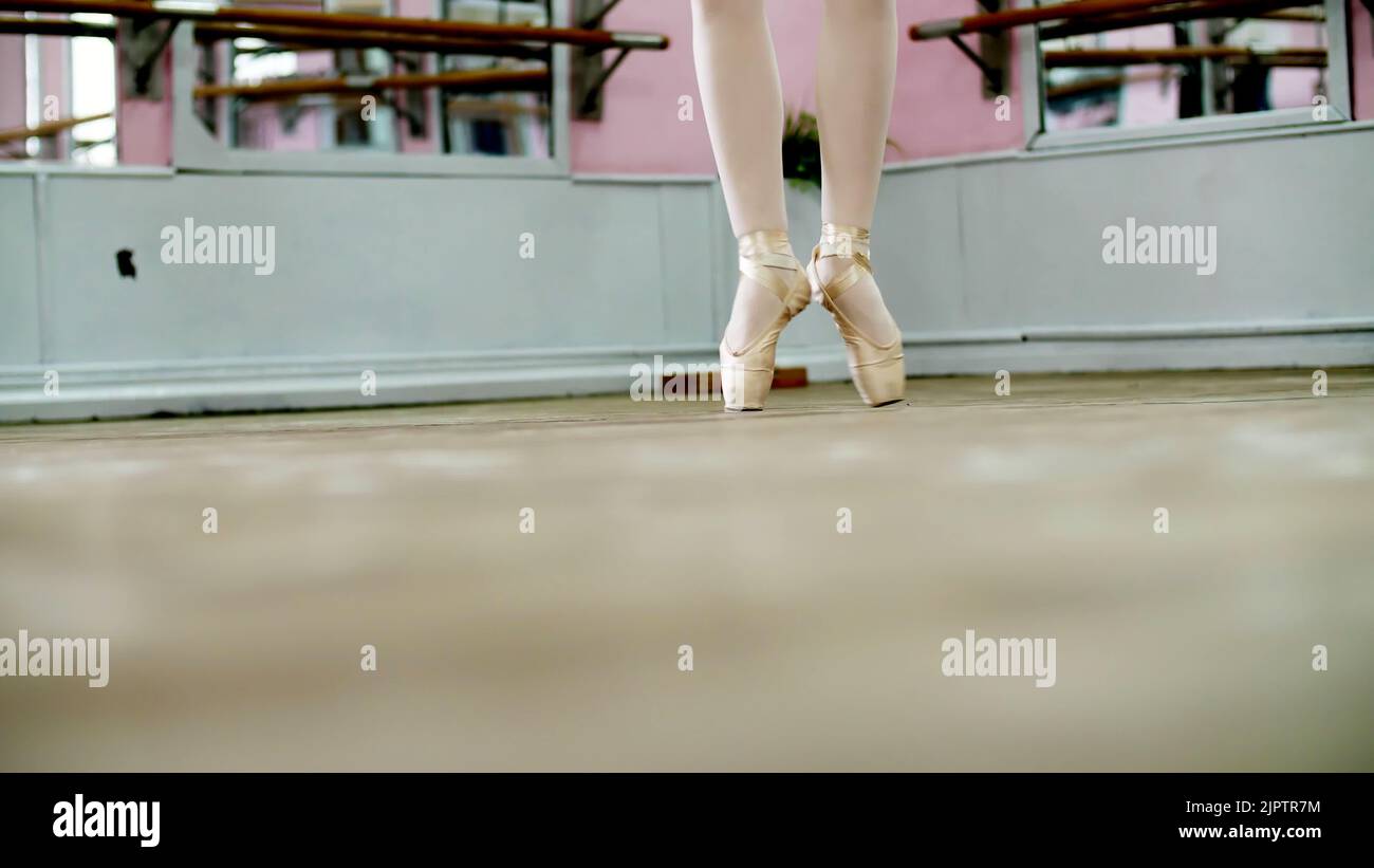 close up, in dancing hall, ballerina perform ssissonne simples , She is ...