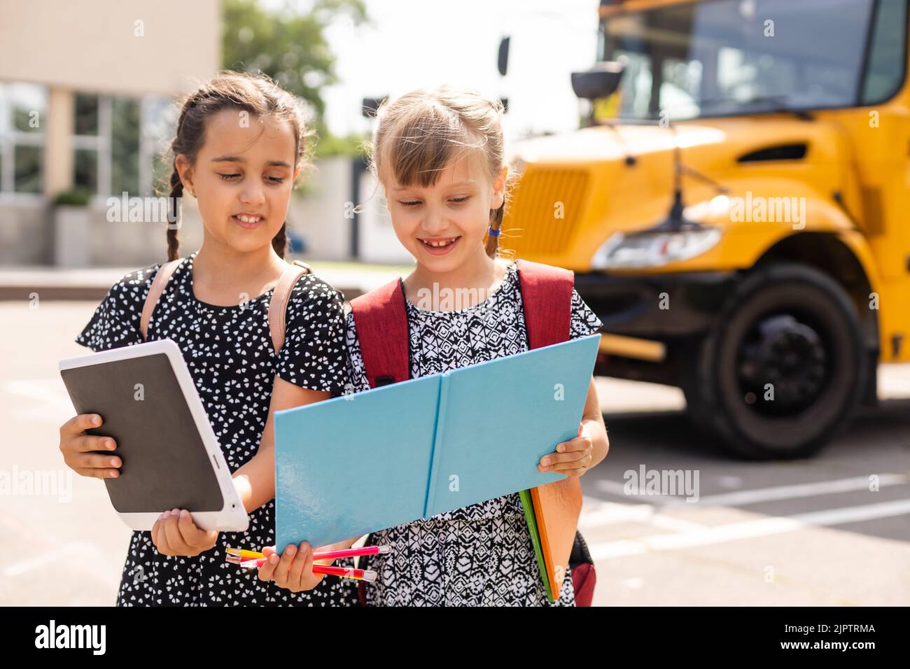 Lucky to meet each other. Cheerful smart schoolgirls. Happy schoolgirls ...