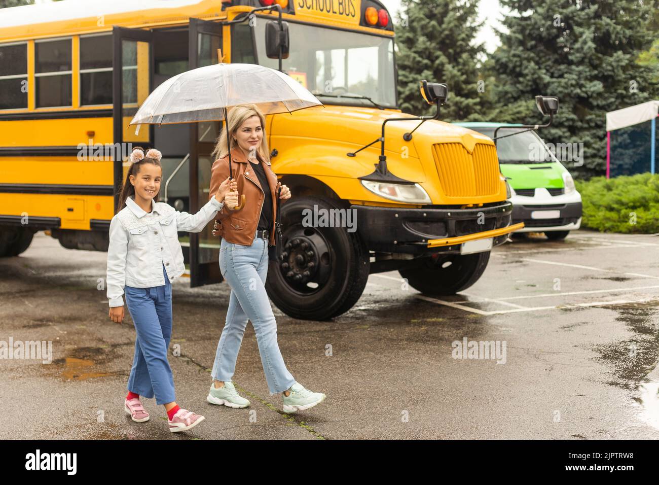 Back to school. Pupils of primary school near school bus. Happy ...