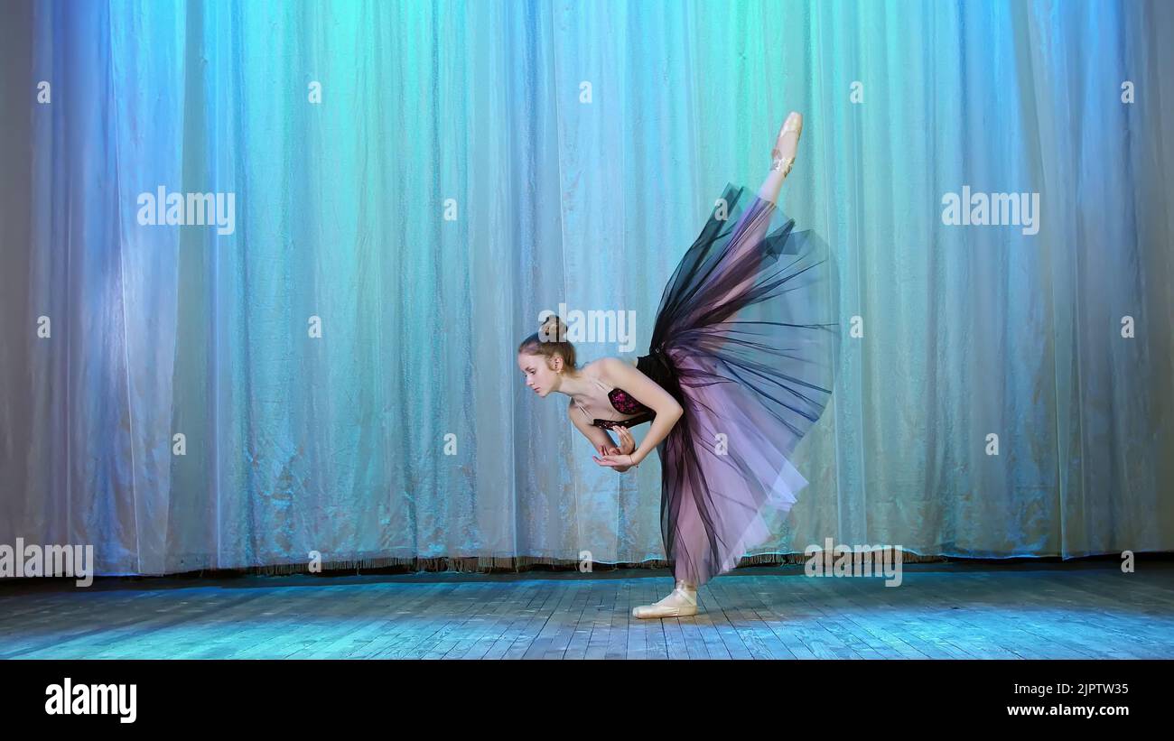 ballet rehearsal, on the stage of the old theater hall. Young ballerina ...
