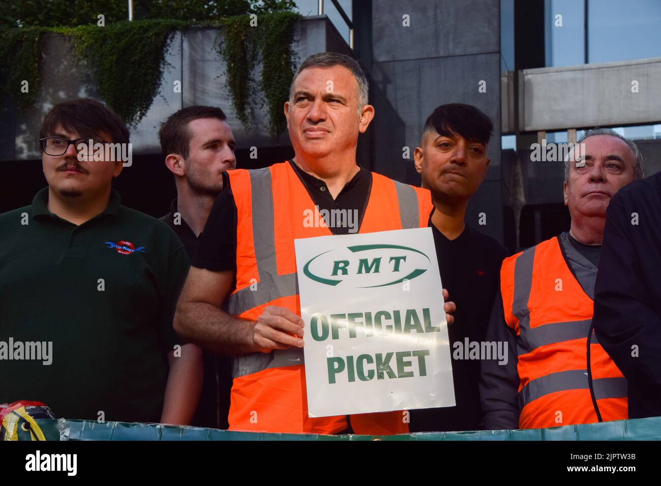 An RMT (Rail, Maritime and Transport) union member holds an "Official ...