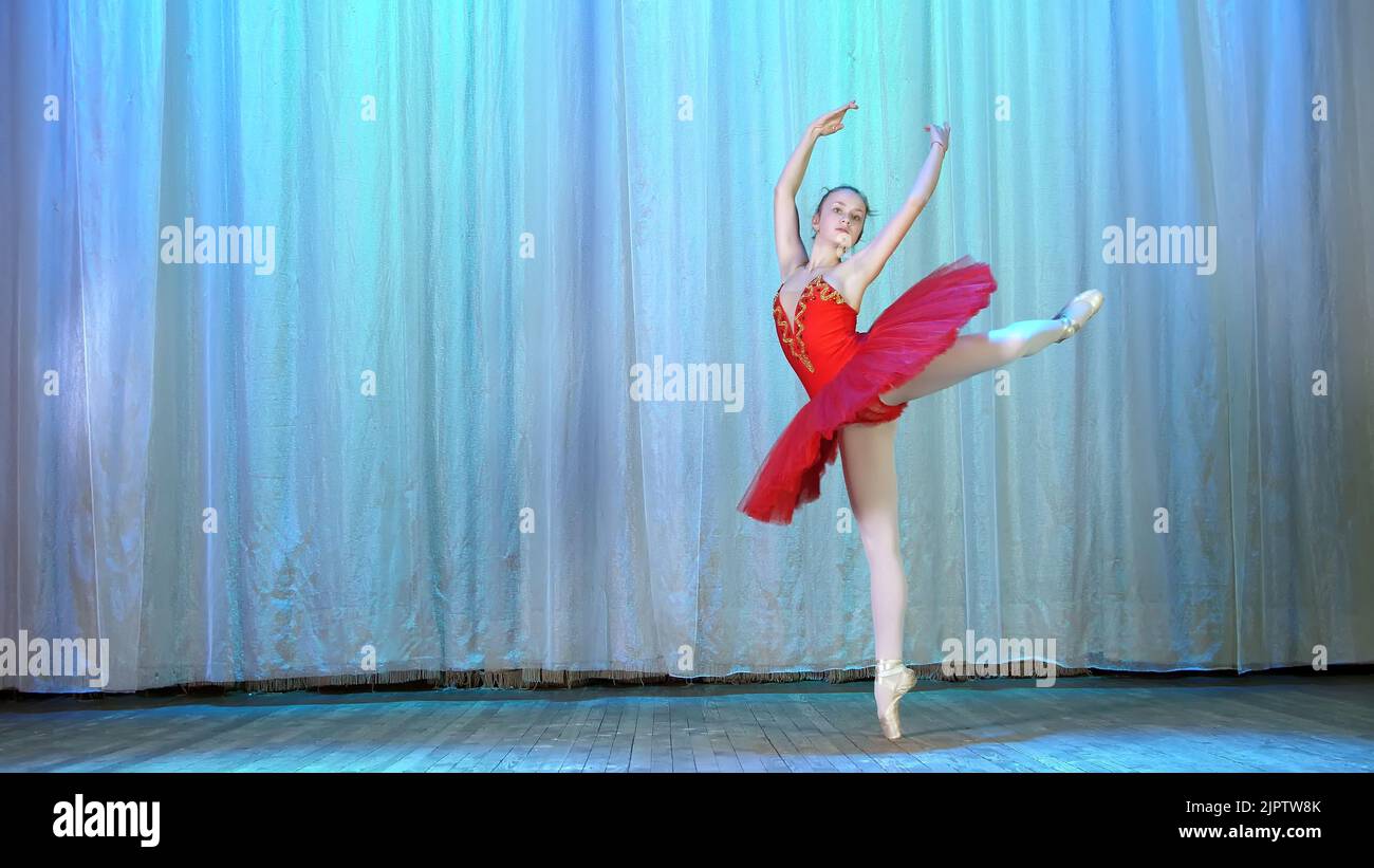 ballet rehearsal, on the stage of the old theater hall. Young ballerina ...