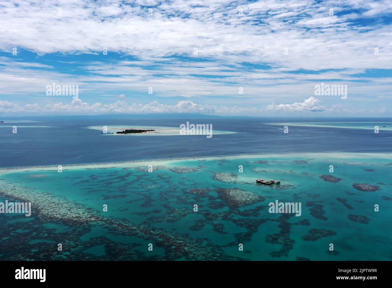 Drone point of view of turquoise colored ocean and reef in Semporna ...