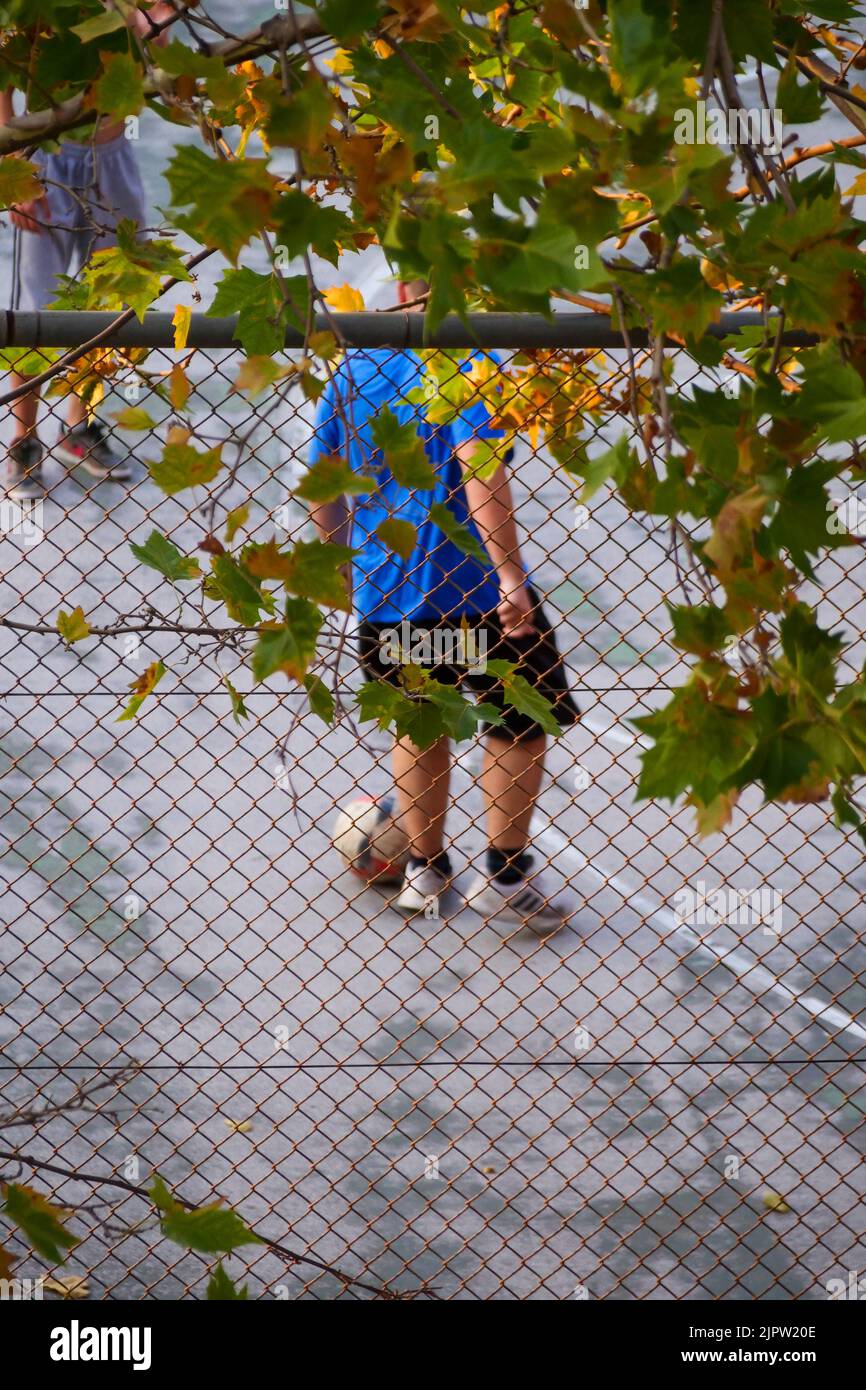 Young boys play football on an urban sportfield, Athens, Attica ...