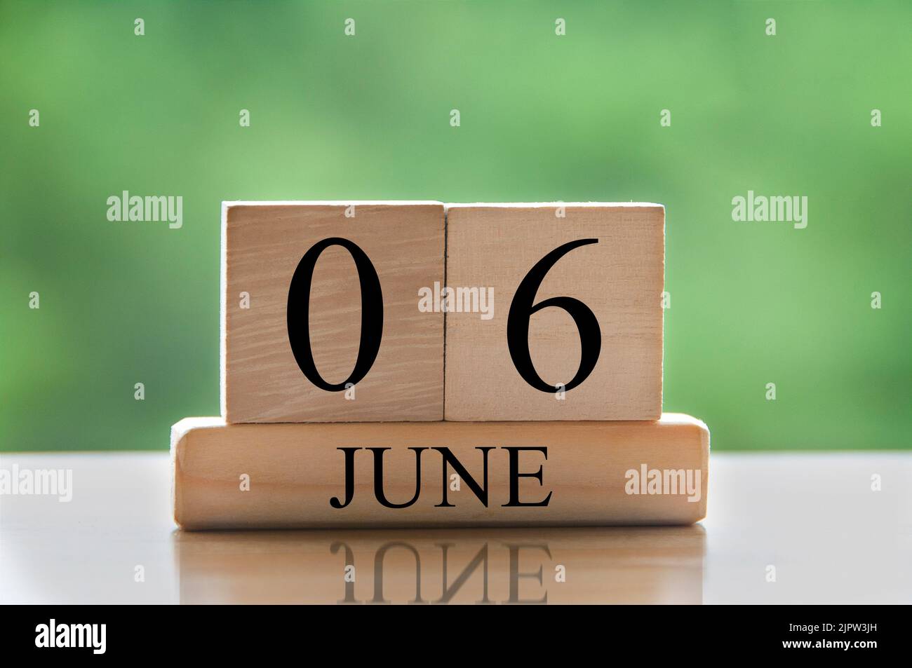 June 6 calendar date text on wooden blocks with blurred nature ...