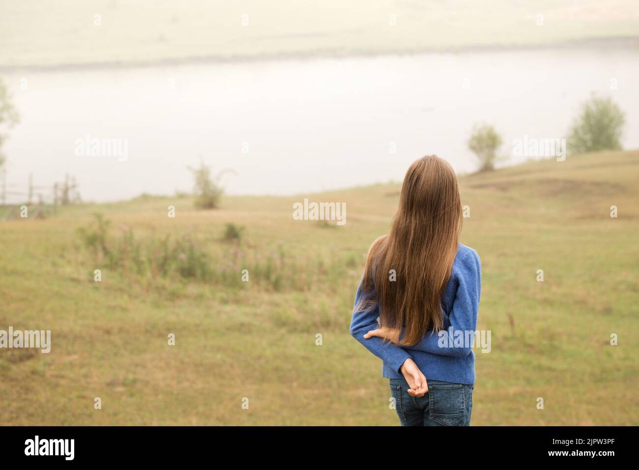 A beautiful young girl was alone in nature in a foggy morning Stock ...