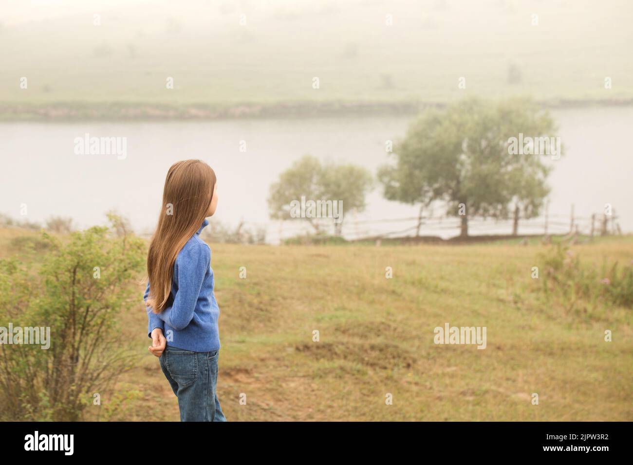 A beautiful young girl was alone in nature in a foggy morning Stock ...