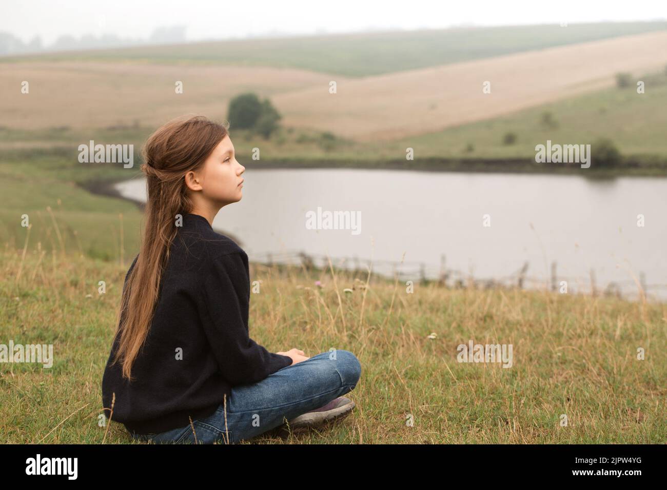 A beautiful young girl was alone in nature in a foggy morning Stock ...