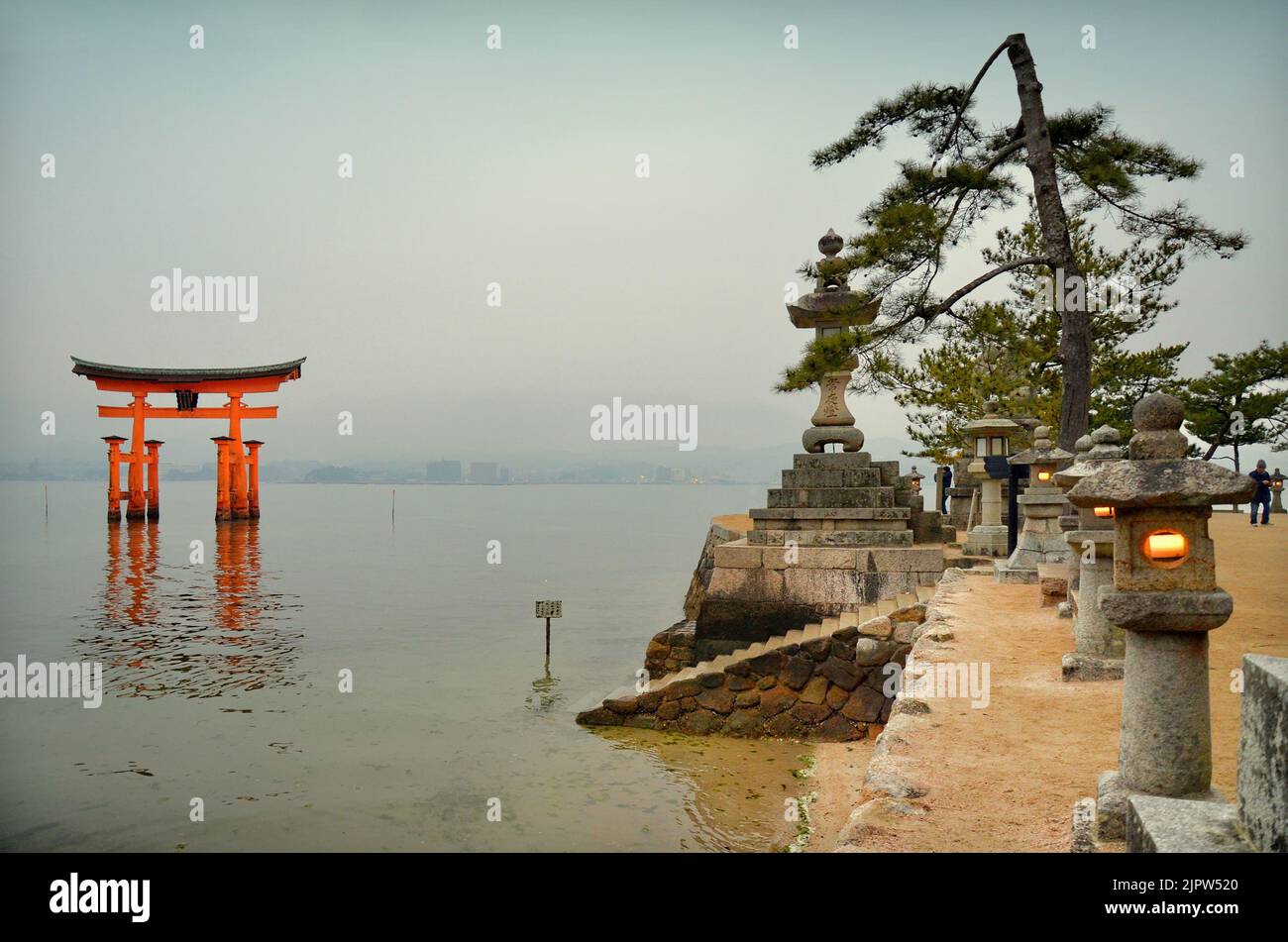 Torii of Miyajima shrine and japanese lanterns. Itsukushima island ...