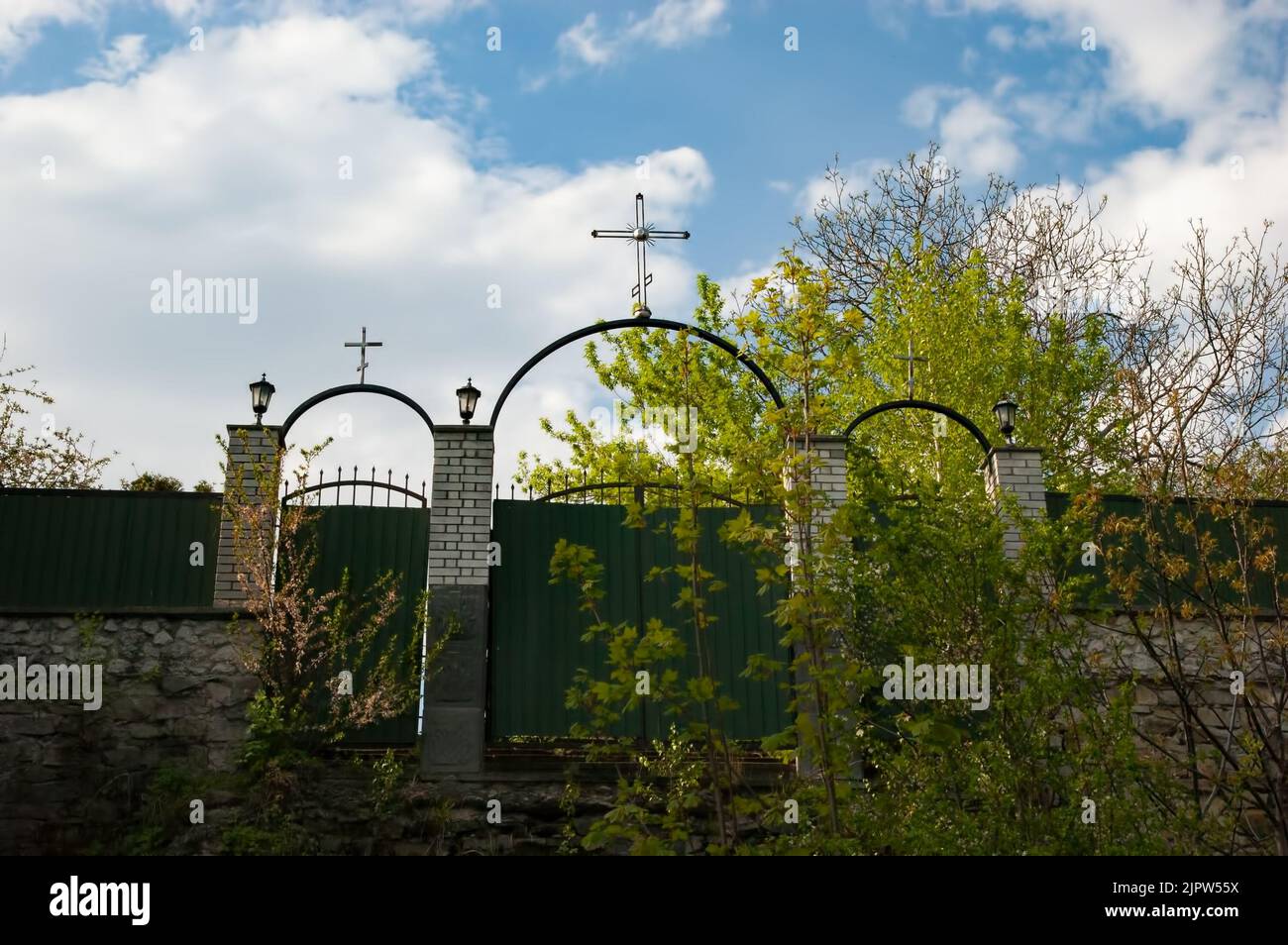 overgrown gate with an Orthodox cross, view from below Stock Photo - Alamy