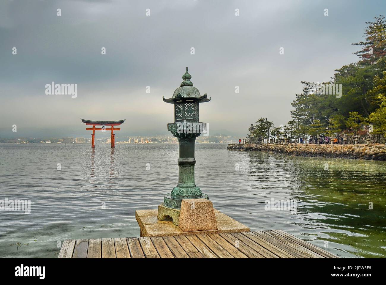 Bronze lantern and torii gate at Miyajima island, Itsukushima ...