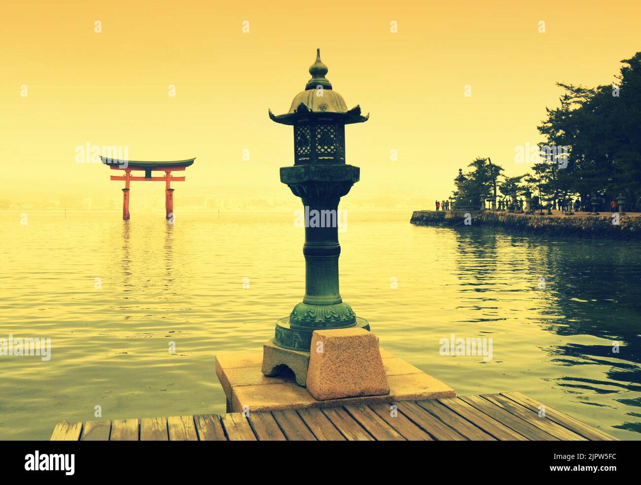 Bronze lantern and torii gate at Miyajima island, Itsukushima ...