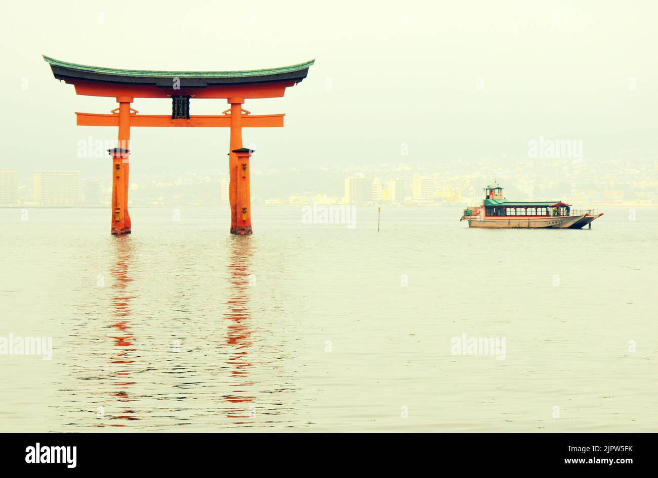 Torii gate and ferry boat at Miyajima island, Itsukushima, Hatsukaichi ...