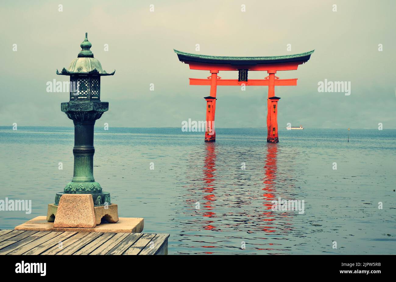 Bronze lantern and torii gate at Miyajima island, Itsukushima ...