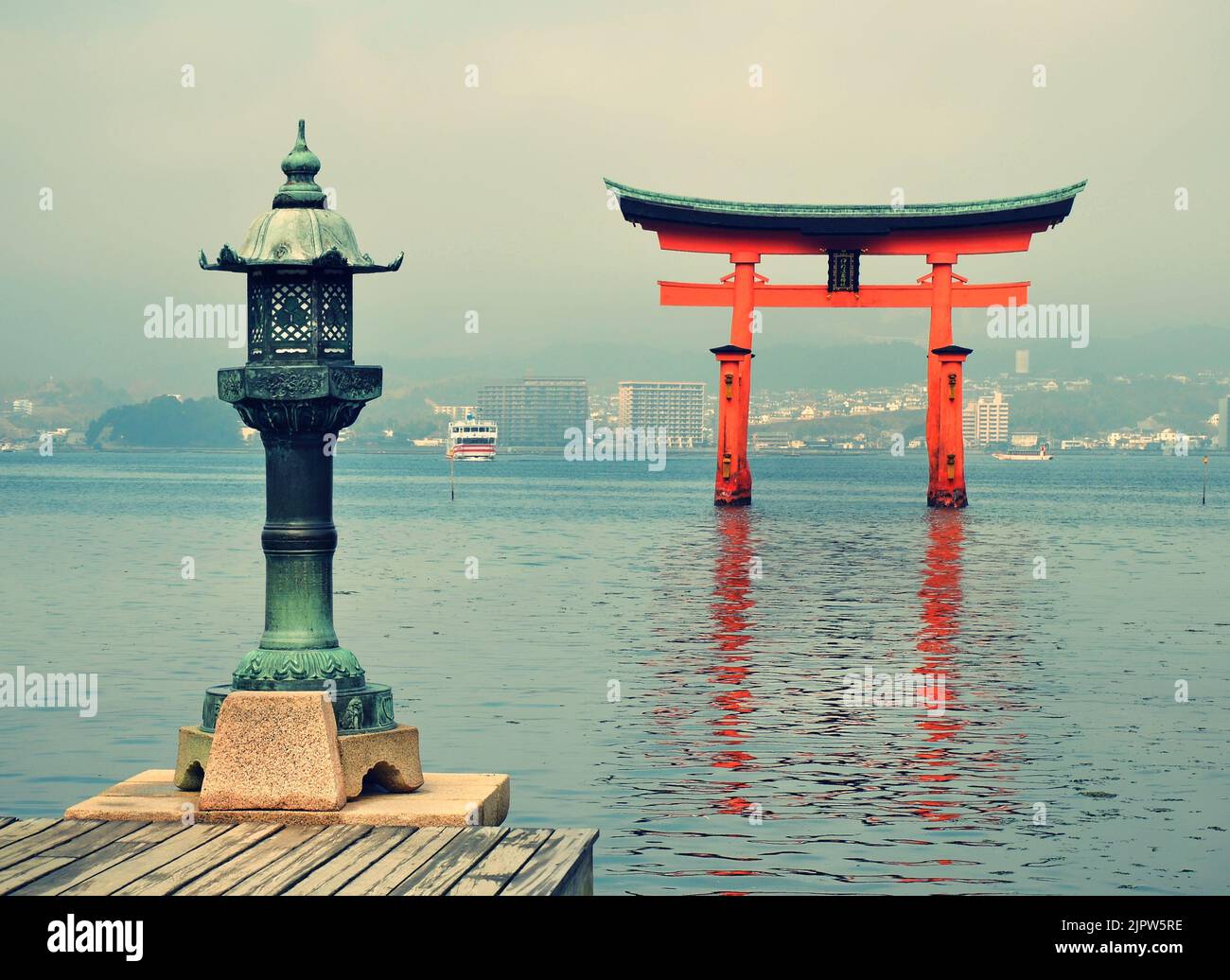 Bronze lantern and torii gate at Miyajima island, Itsukushima ...