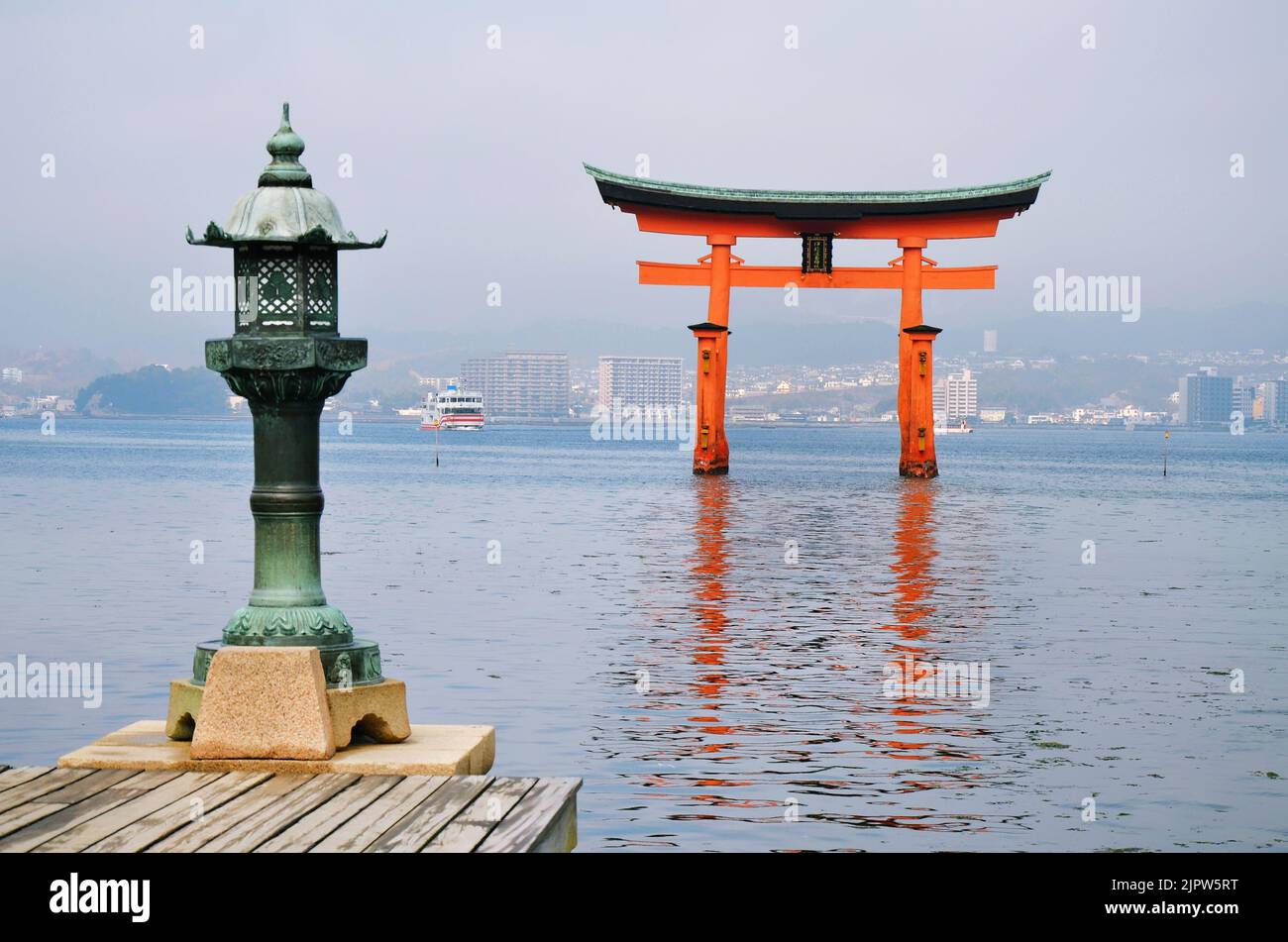 Bronze lantern and torii gate at Miyajima island, Itsukushima ...