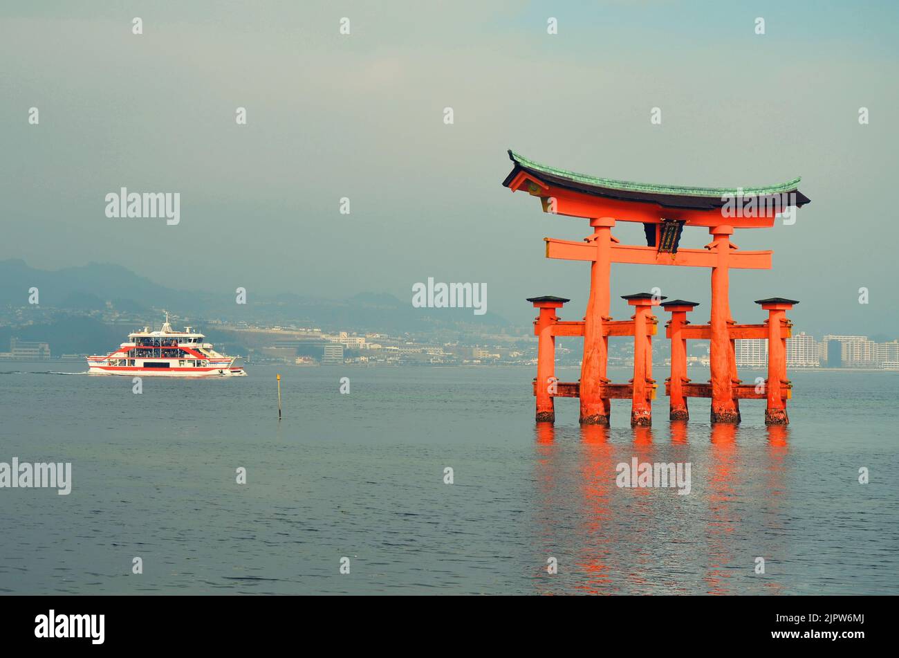 Torii gate and ferry boat at Miyajima island, Itsukushima, Hatsukaichi ...