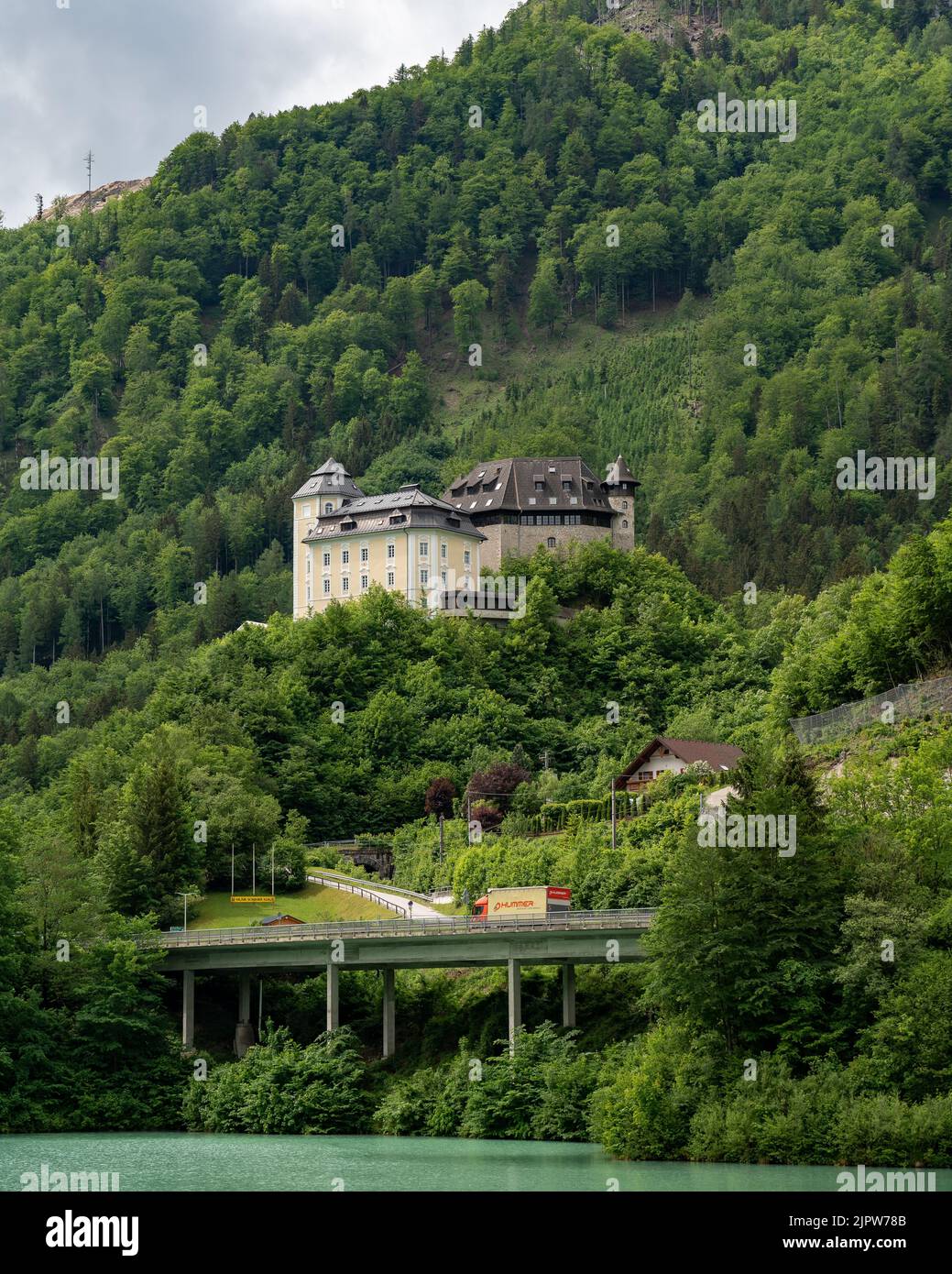The historic building of Klaus castle on the hill above Klaus dam in ...