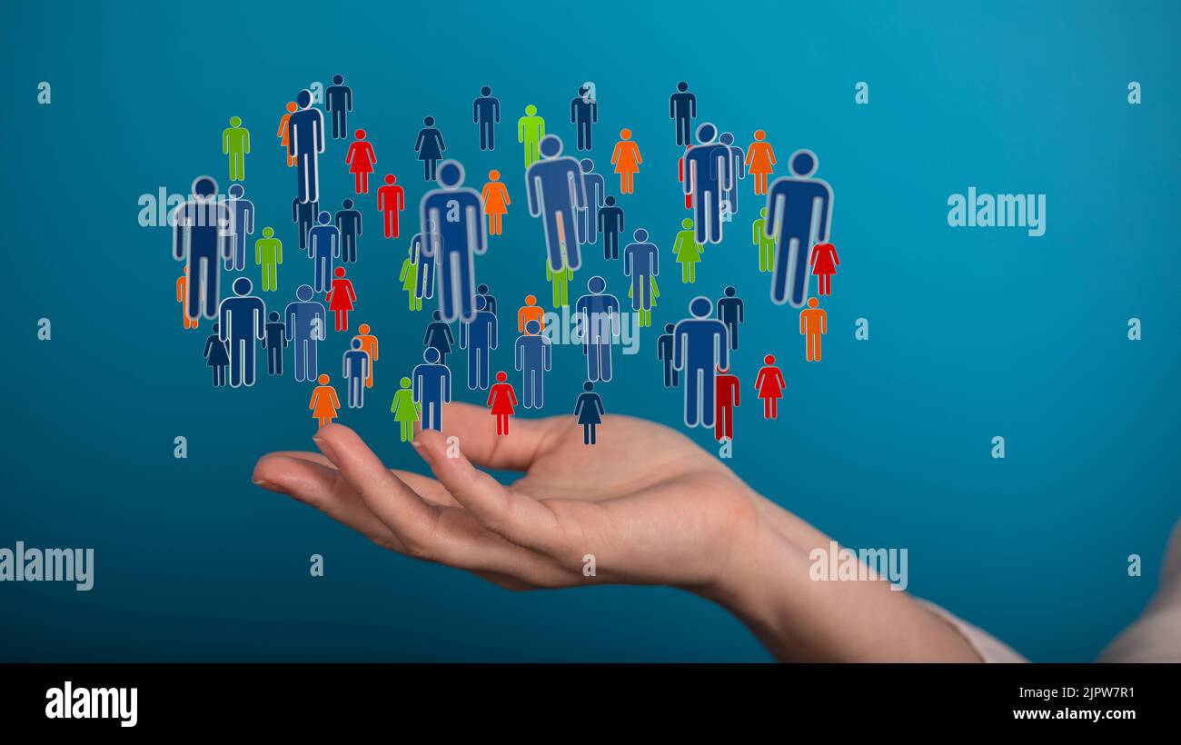 A person's hand holding colorful hovering people icons Stock Photo - Alamy