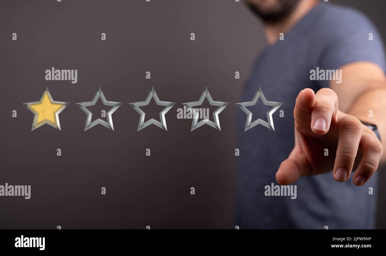 A person's hand pointing at hovering stars. Rating, evaluation Stock ...