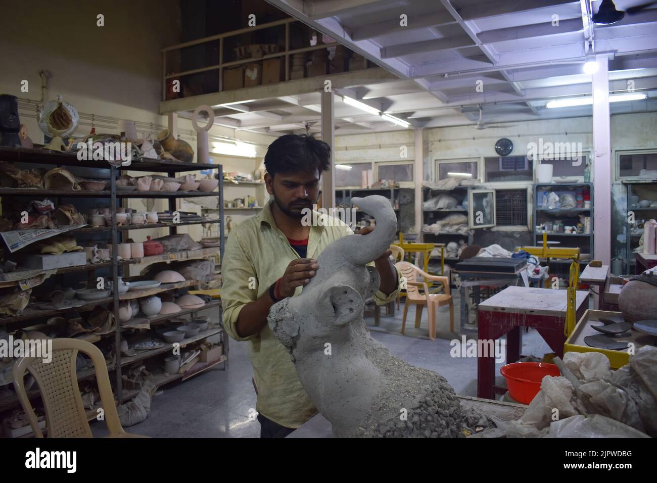 An artist is making a sculpture in his workshop Stock Photo - Alamy