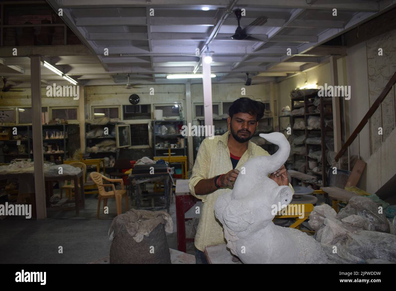 An artist is making a sculpture in his workshop Stock Photo - Alamy