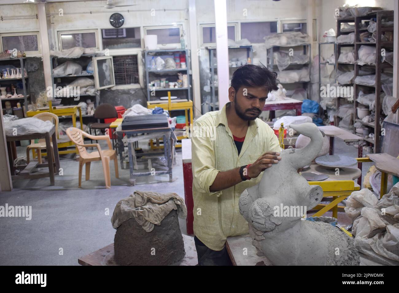 An artist is making a sculpture in his workshop Stock Photo - Alamy