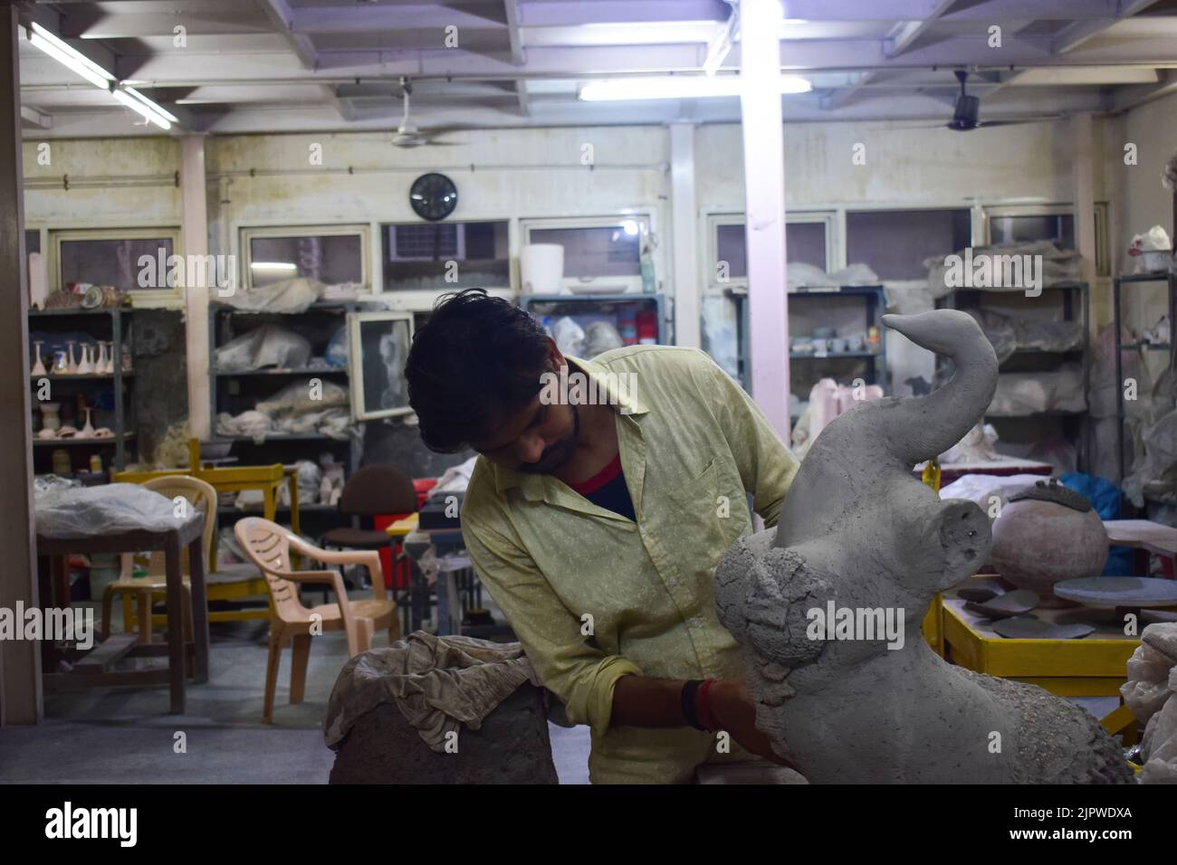 An artist is making a sculpture in his workshop Stock Photo - Alamy
