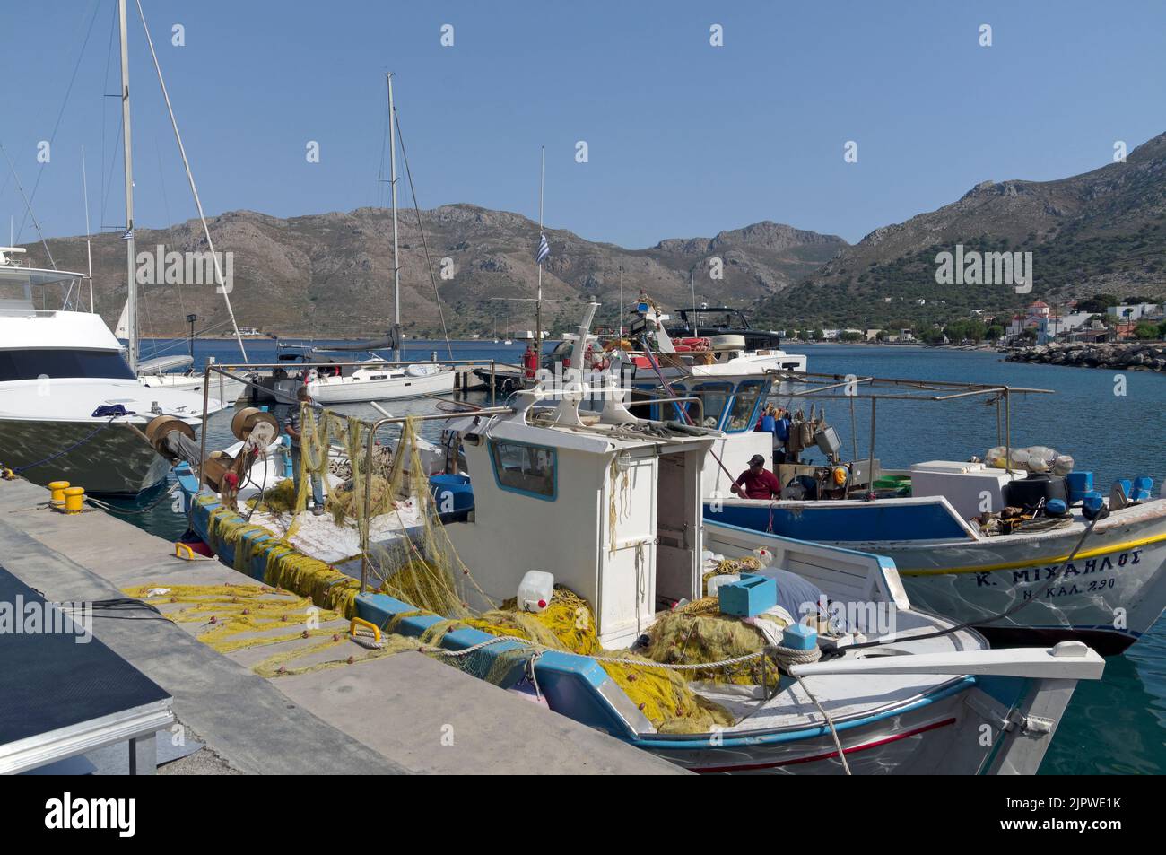 Traditional fishing boats and yachts, Livadia harbour and boats. Tilos ...